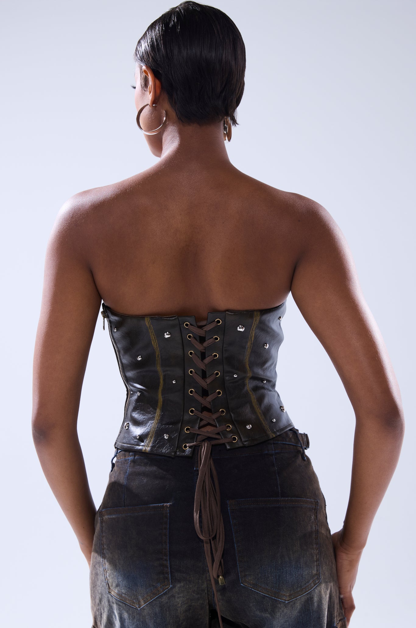 HARD TO PLEASE STUDDED FAUX LEATHER CORSET – AKIRA