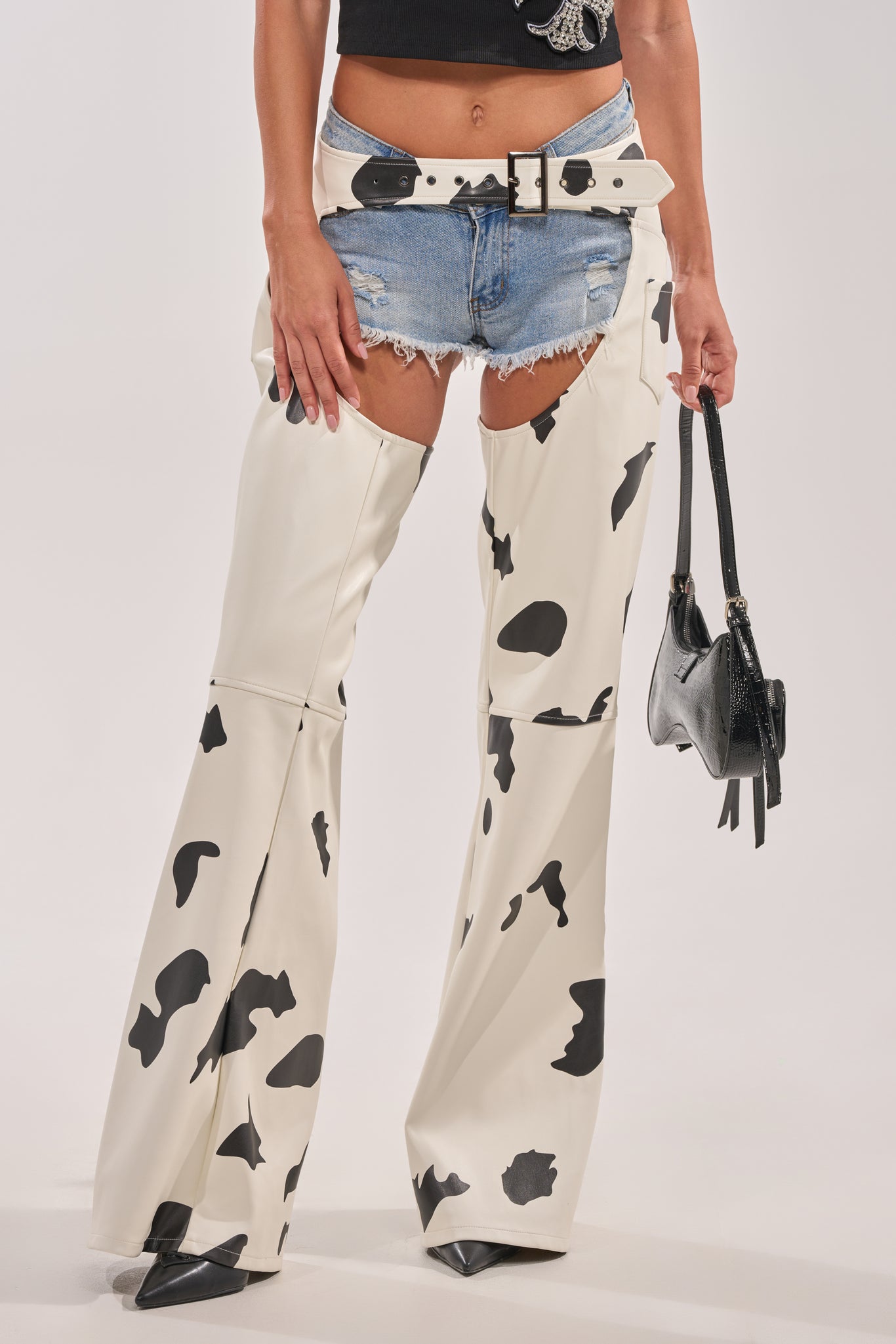 MOO OVER COW PRINT FAUX LEATHER CHAPS – AKIRA